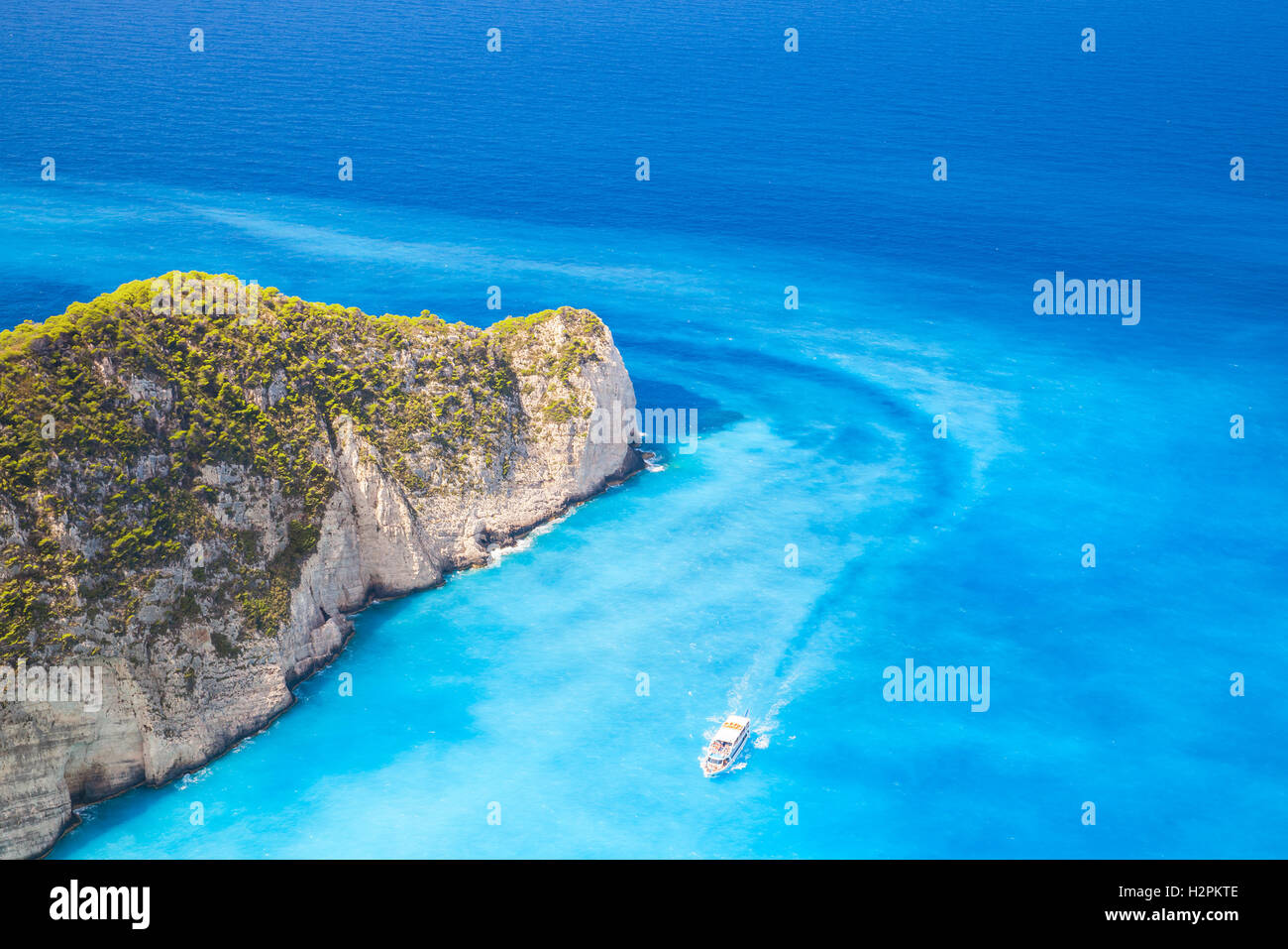 Touristic motor boat goes on Navagio Bay to the Ship Wreck beach. The ...