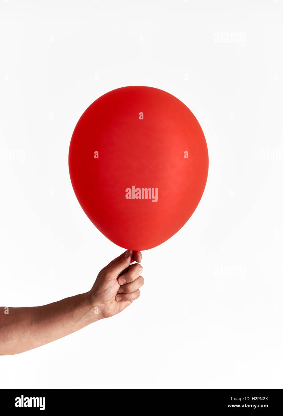 Man holding red balloon on white background Stock Photo - Alamy