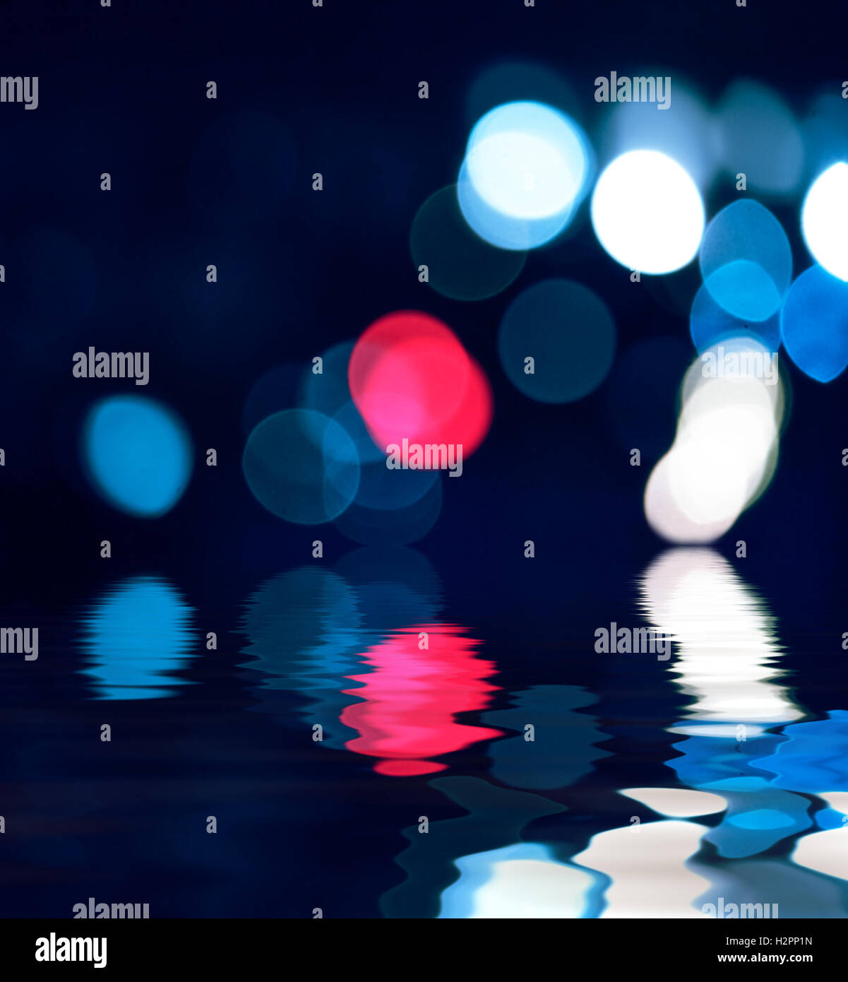 Blurred reflection in water of defocused lights at night Stock Photo ...