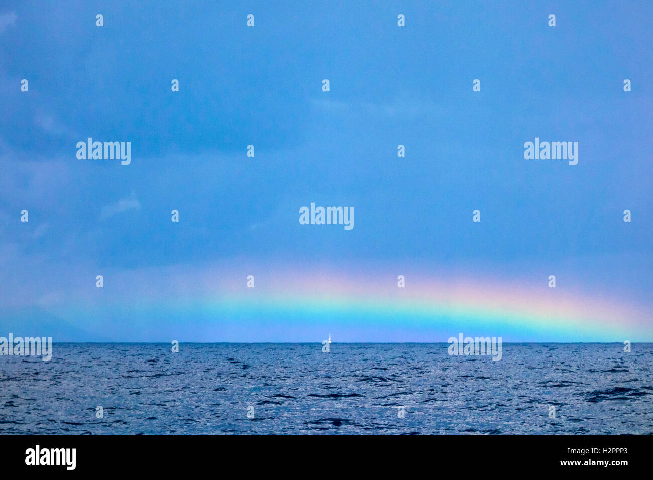 Sailing ship passing through a rainbow Stock Photo - Alamy