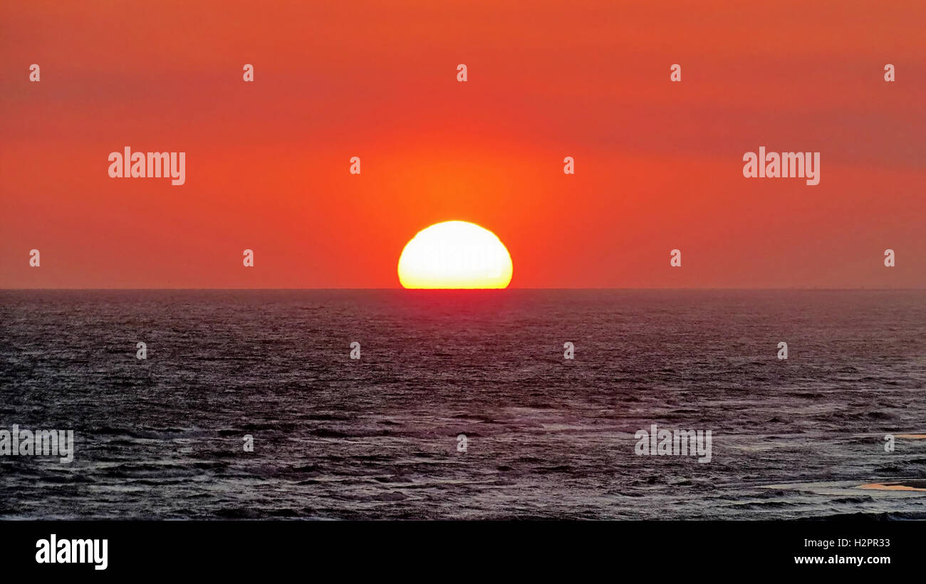 A brilliant red sun sunset over the ocean near Perdido Key, Florida ...