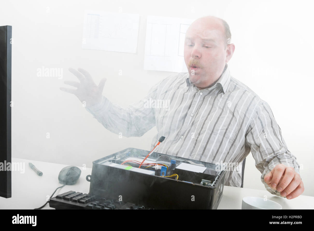 Businessman Blowing Smoke Emerging From Computer Chassis Stock Photo ...