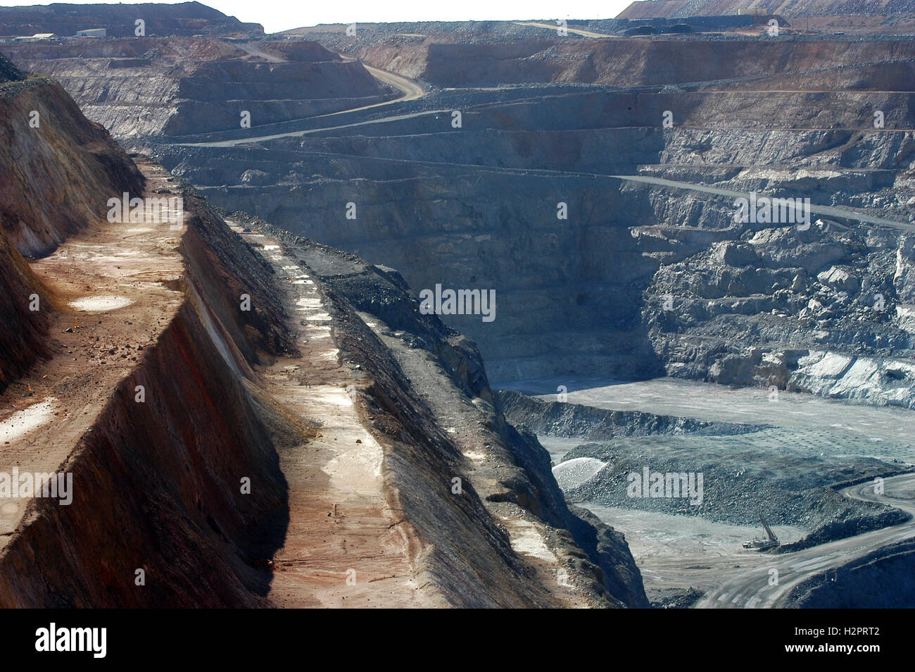 View inside the huge hole and big machines of the gold mine in ...