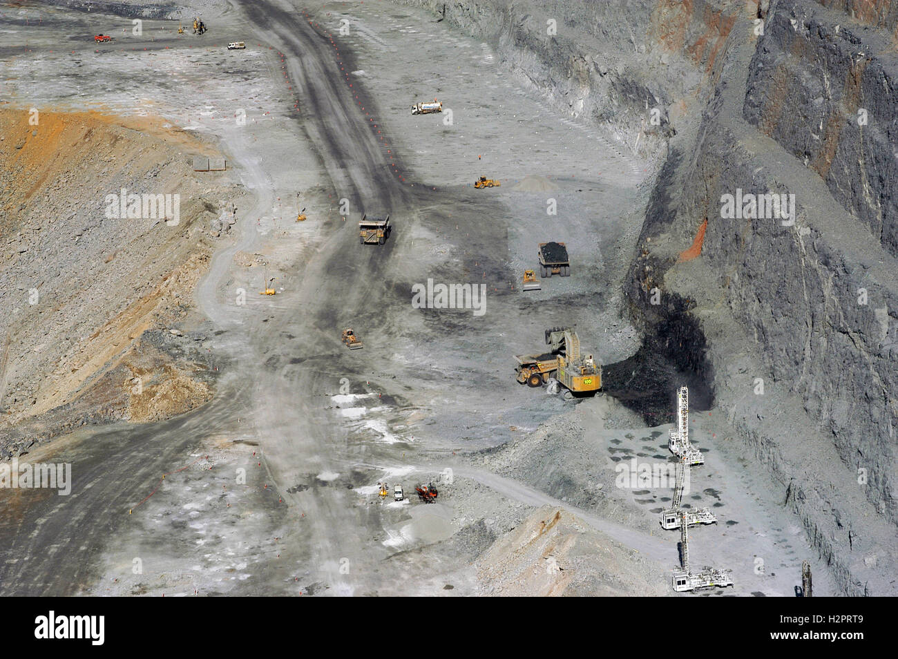 View inside the huge hole and big machines of the gold mine in ...