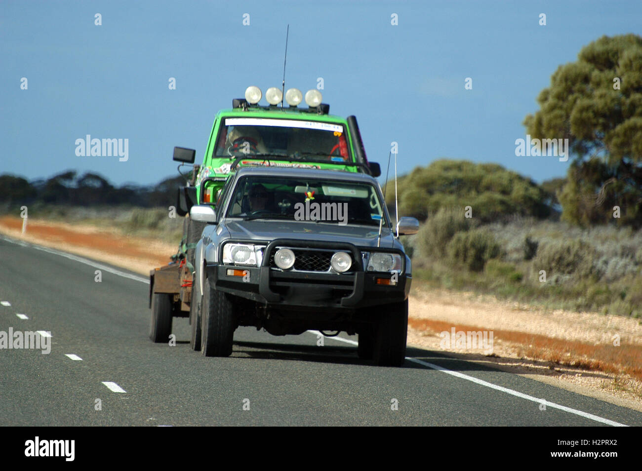Country vehicle carrying a racing car on the road in Australia Stock ...