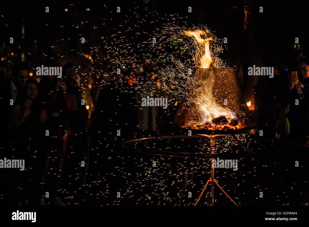 At night a rotating structure with a fire inside turns at speed ...