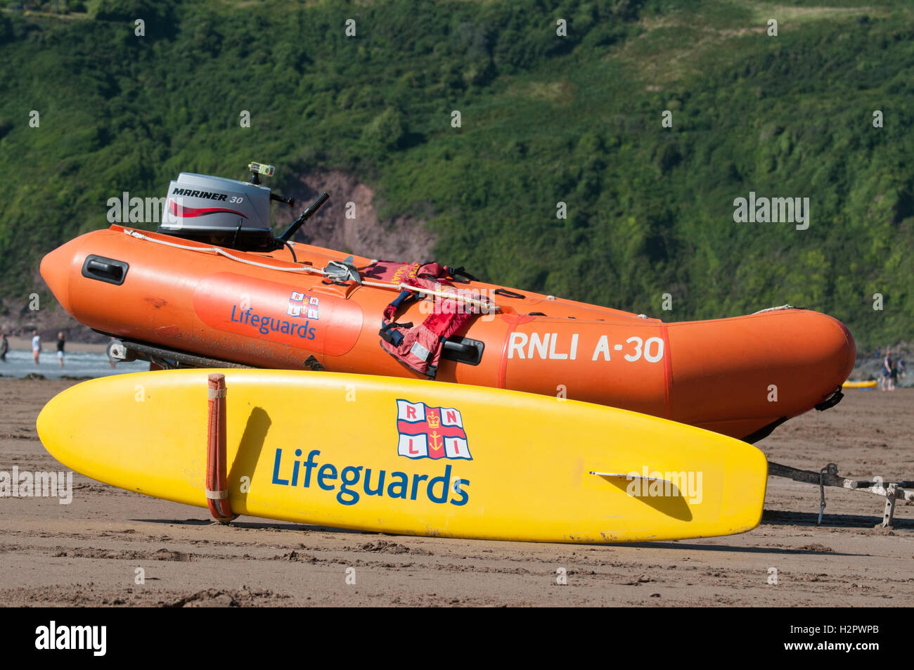 RNLI Arancia inshore lifeboat and surfboard Stock Photo - Alamy