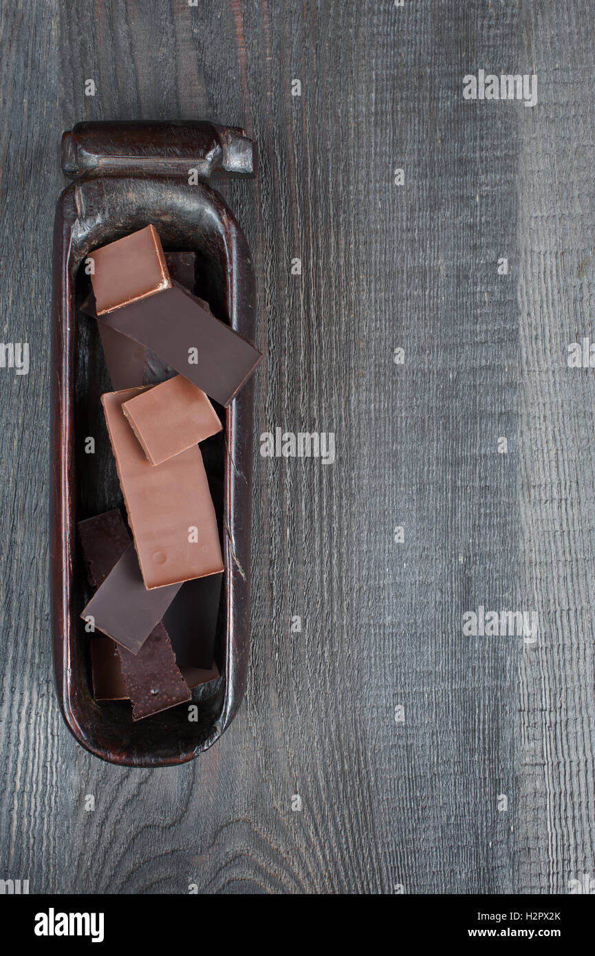 Wooden container with pieces of chocolate Stock Photo - Alamy