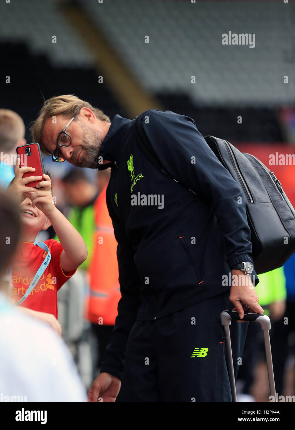 Liverpool manager Jurgen Klopp takes a picture with a young fan before ...