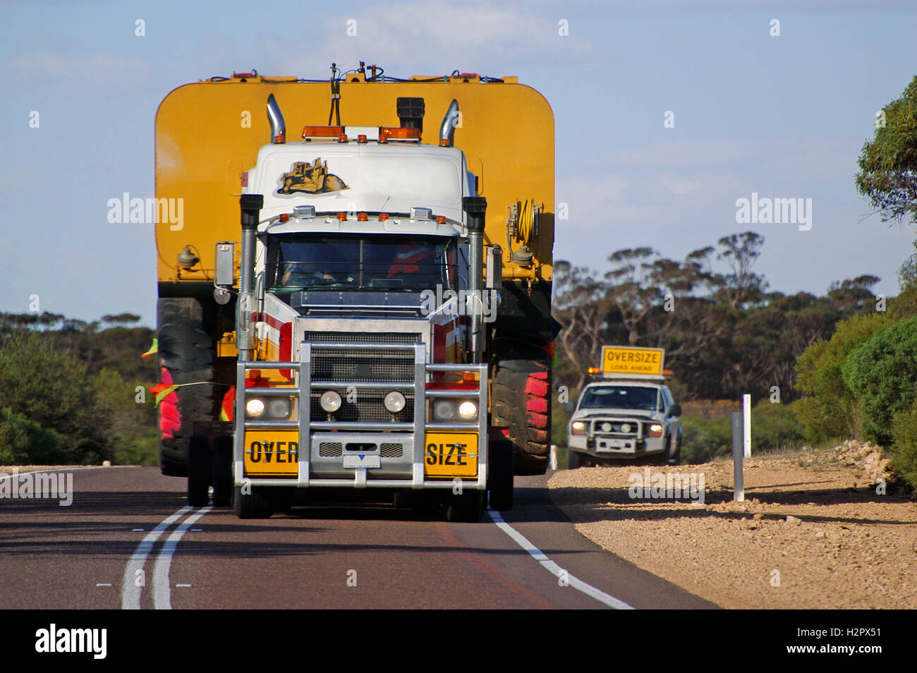 Australian A big truck with a huge load followed by a pilot car to ...