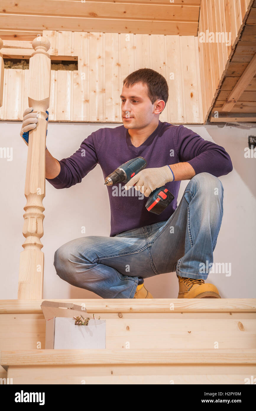 a young worker sitting and holding cordless drill Stock Photo - Alamy