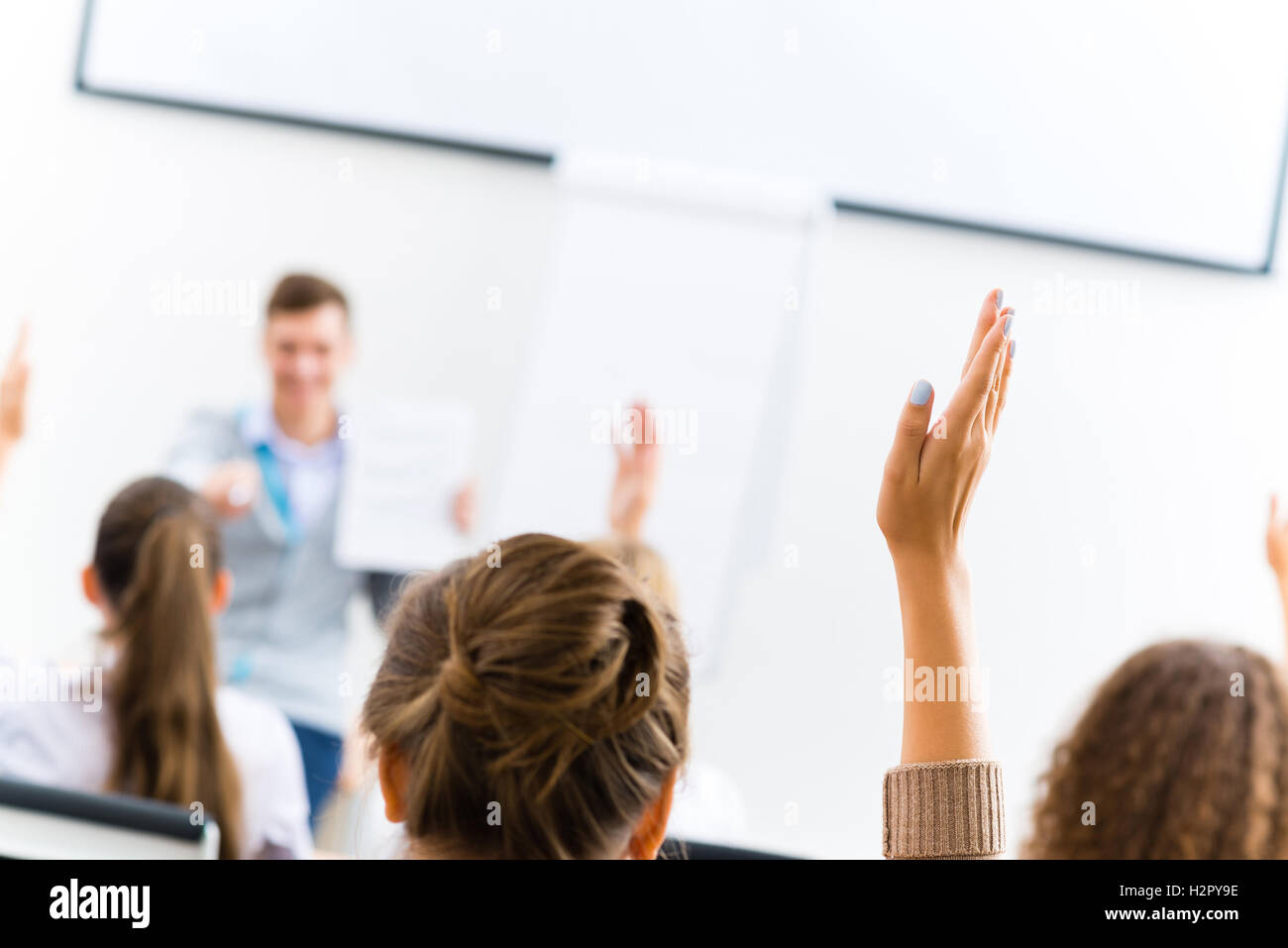 female hand raised in class Stock Photo - Alamy