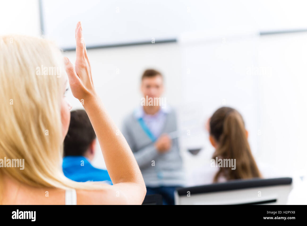 female hand raised in class Stock Photo - Alamy