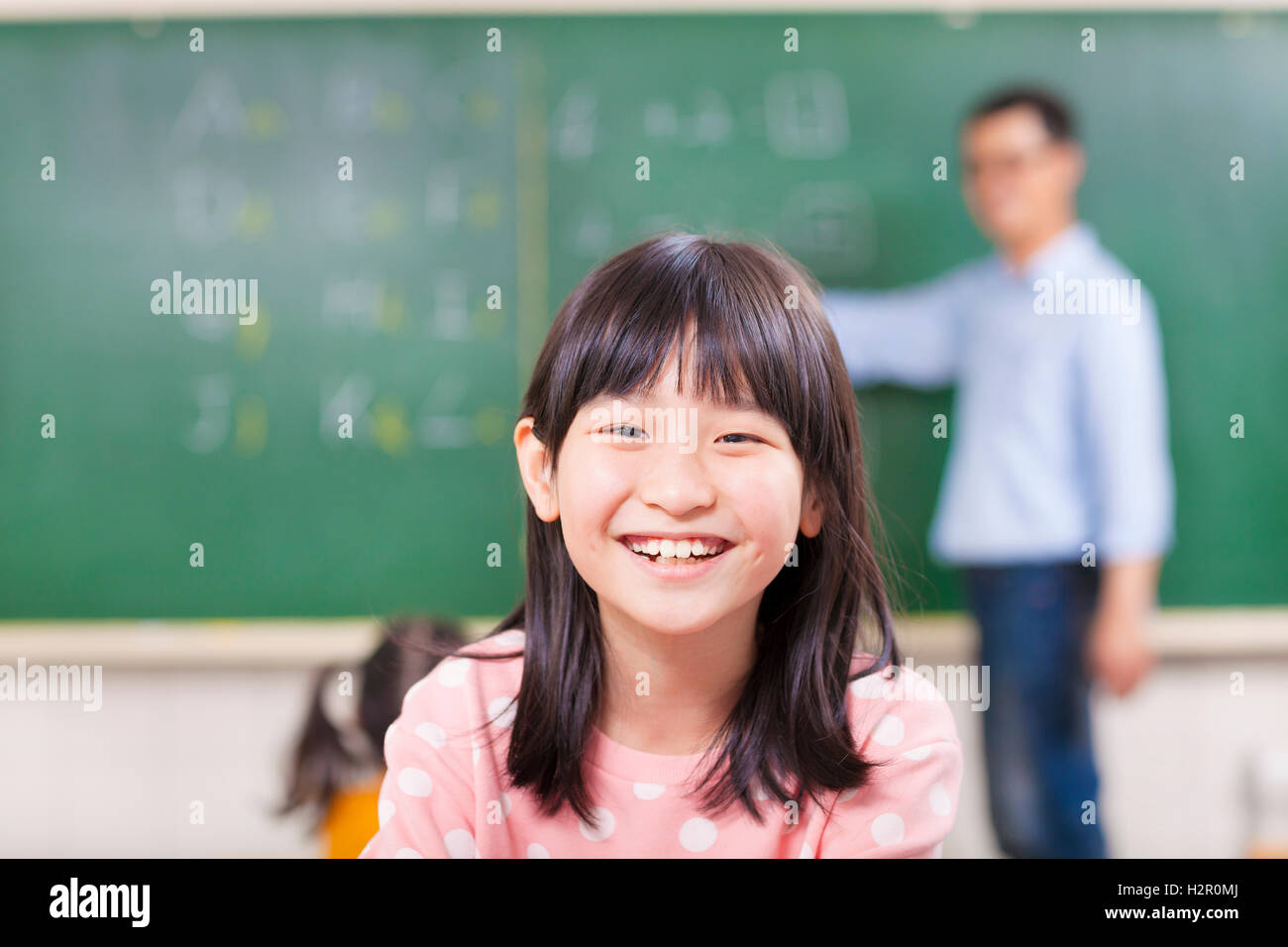 close-up pupils smiling in class with teacher Stock Photo - Alamy