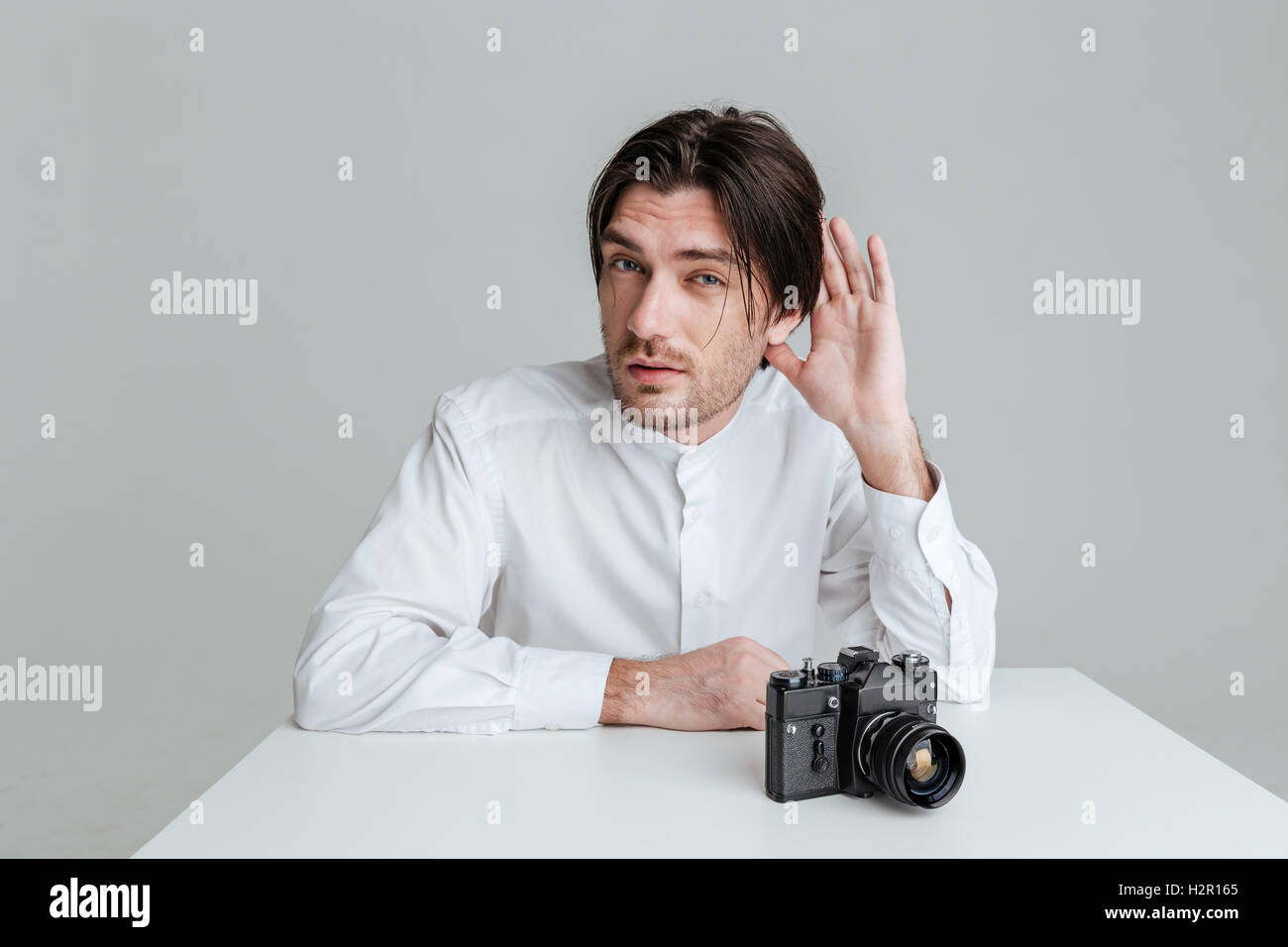 Young bristled brunette man which overhears conversation while sitting ...