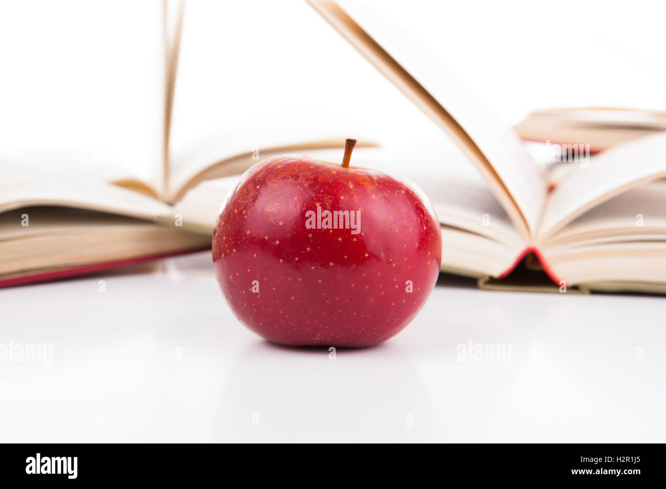 open books with red apple Stock Photo - Alamy