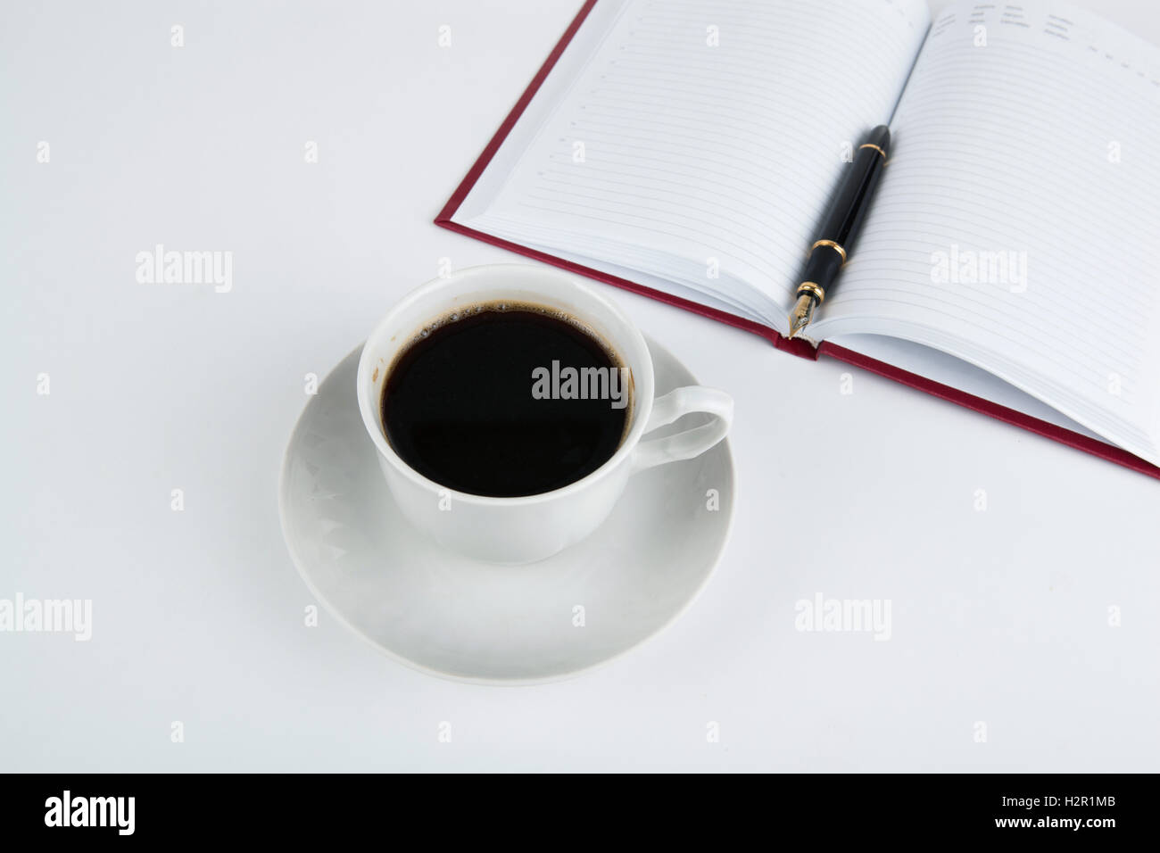 Cup of coffee with diary with fountain pen Stock Photo - Alamy