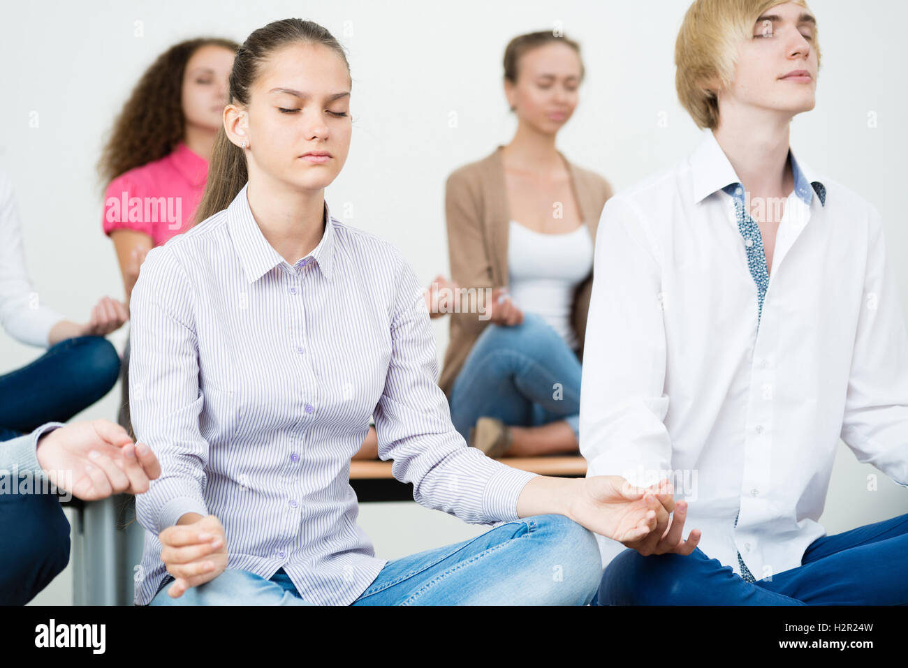 group of young people meditating Stock Photo - Alamy
