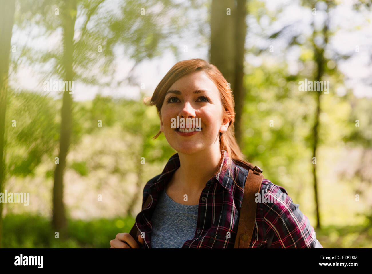 Portrait smiling woman with red hair hiking in woods Stock Photo - Alamy