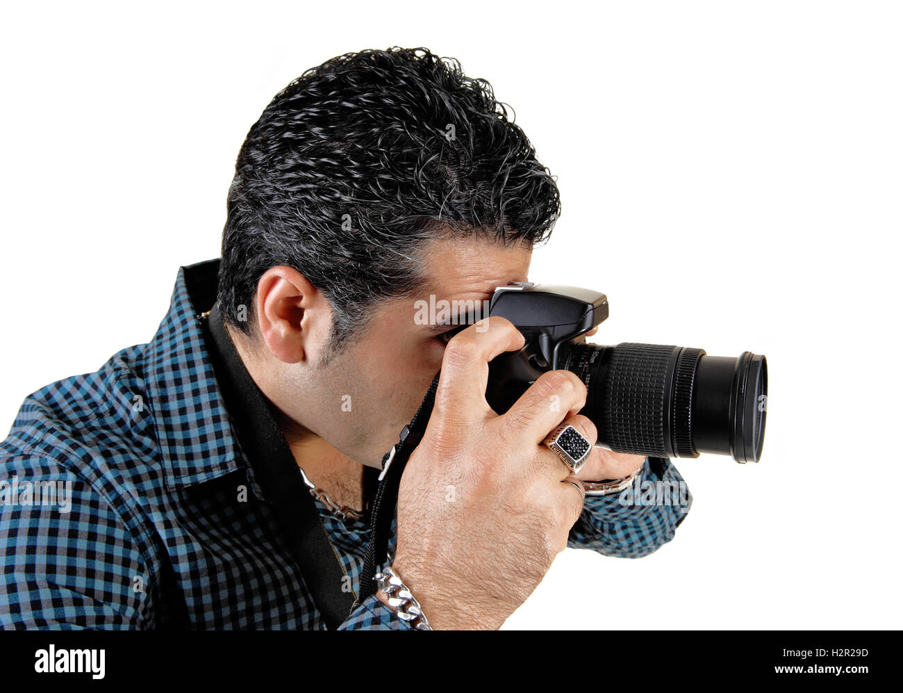 A young handsome man standing and taking pictures with his camera for ...