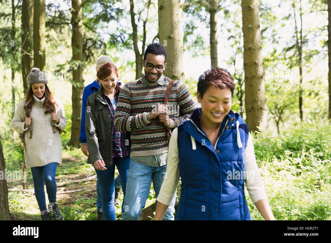 Friends hiking in woods Stock Photo - Alamy