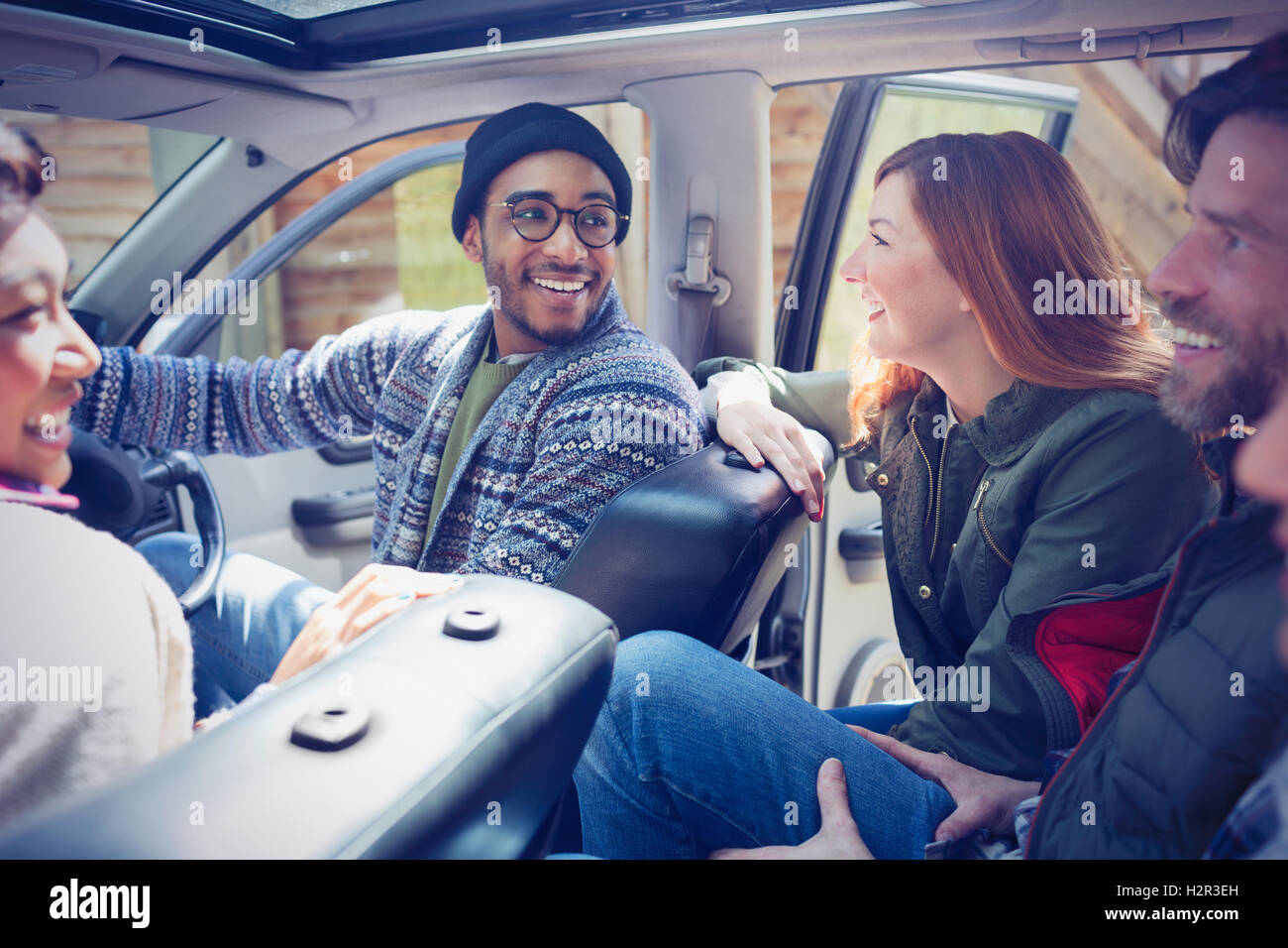Smiling friends talking and riding in car Stock Photo - Alamy