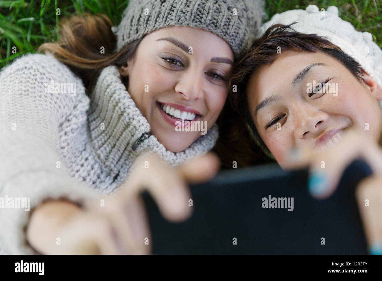 Overhead smiling female friends taking selfie with camera phone Stock ...