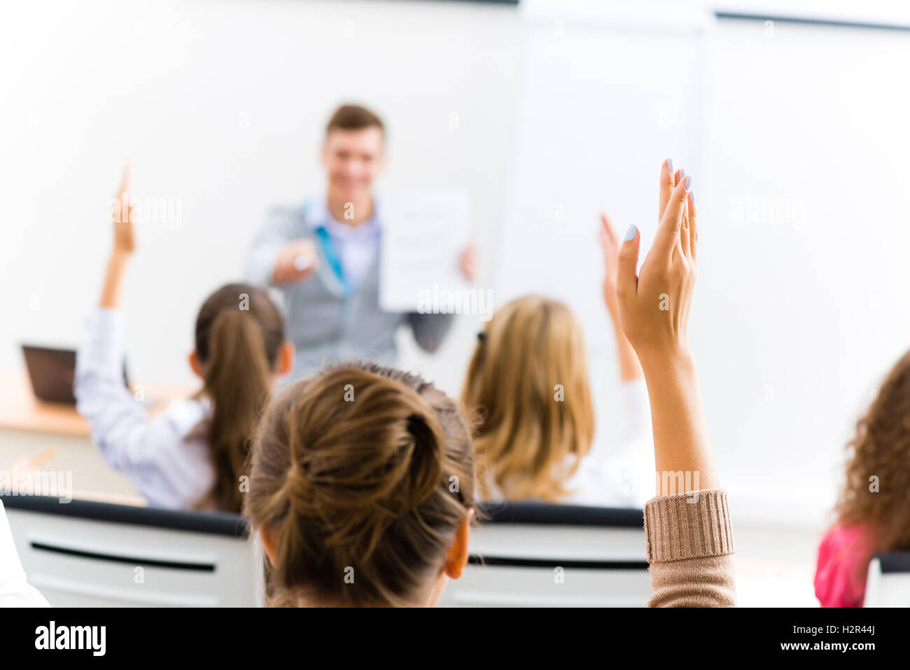 female hand raised in class Stock Photo - Alamy