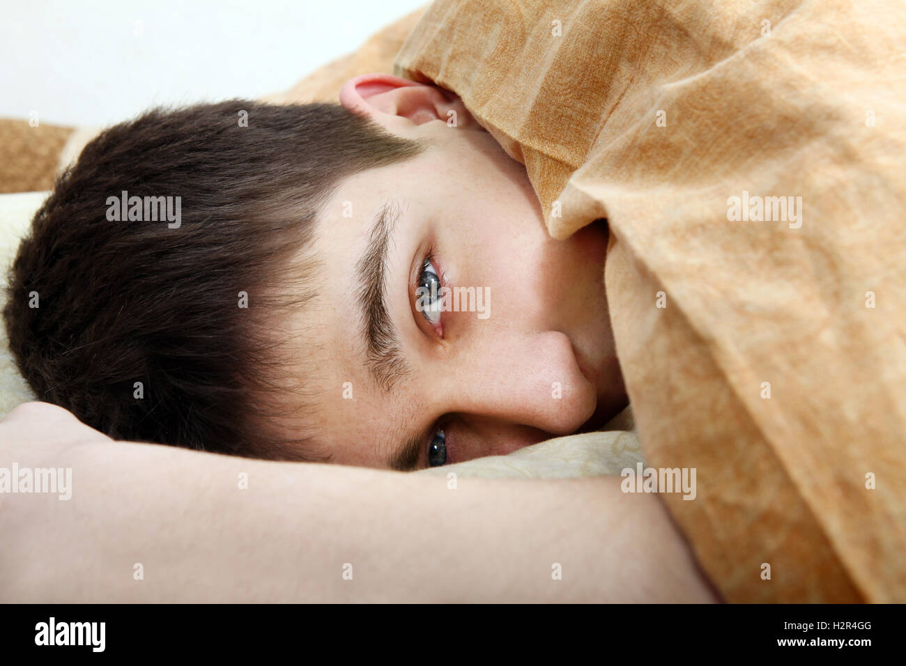 Tired Teenager Under Blanket Stock Photo - Alamy