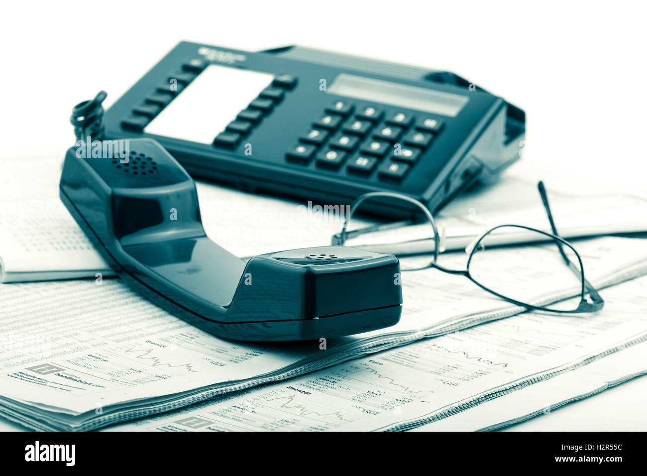 Vintage telephone handset on table with newspaper Stock Photo - Alamy