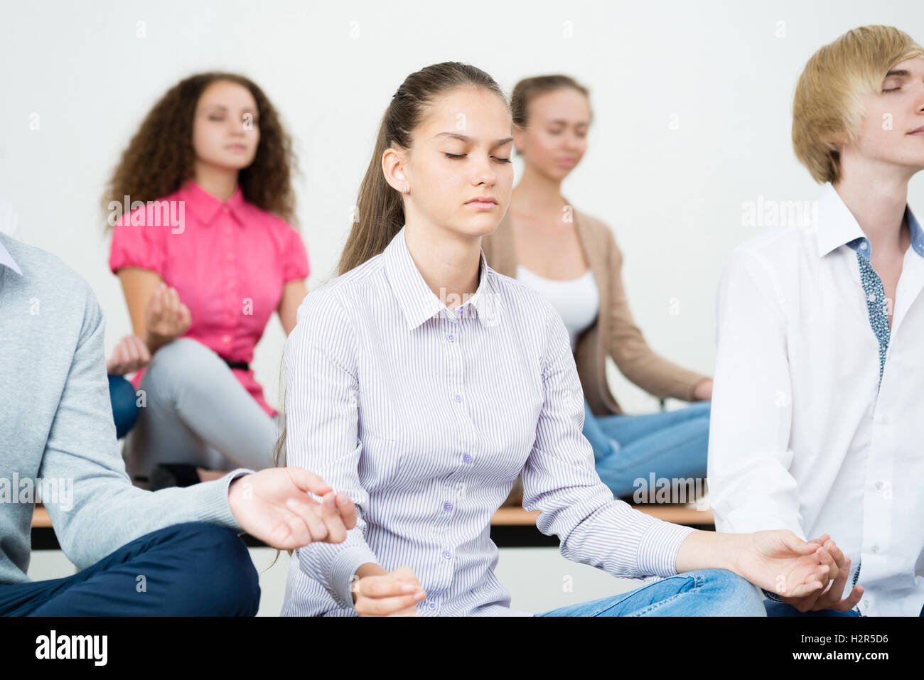 group of young people meditating Stock Photo - Alamy