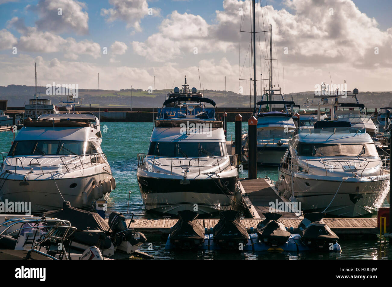 Three large power boats in Torquay marina Stock Photo - Alamy