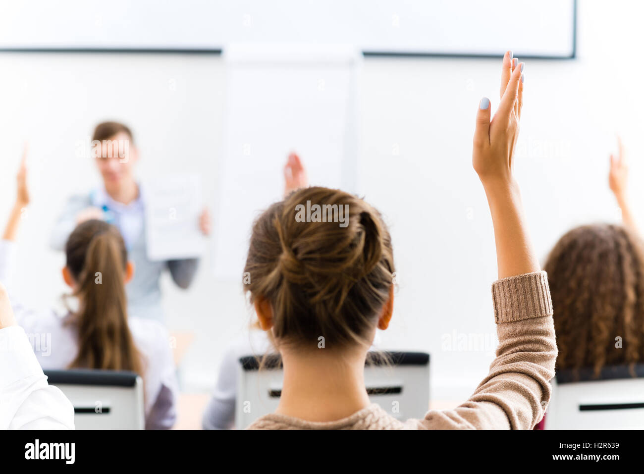 female hand raised in class Stock Photo - Alamy