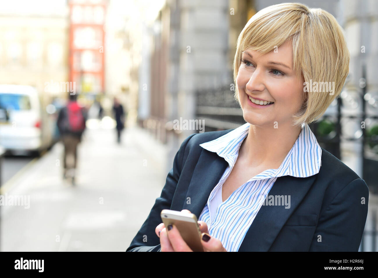 Female employee operating smartphone hi-res stock photography and ...