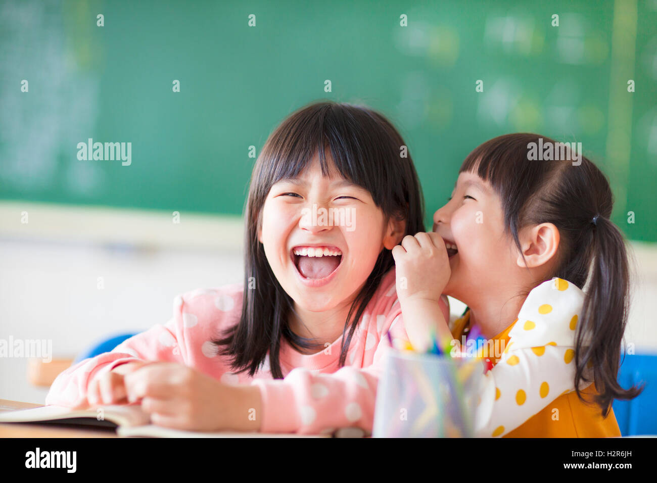 Girls whispering class hi-res stock photography and images - Alamy