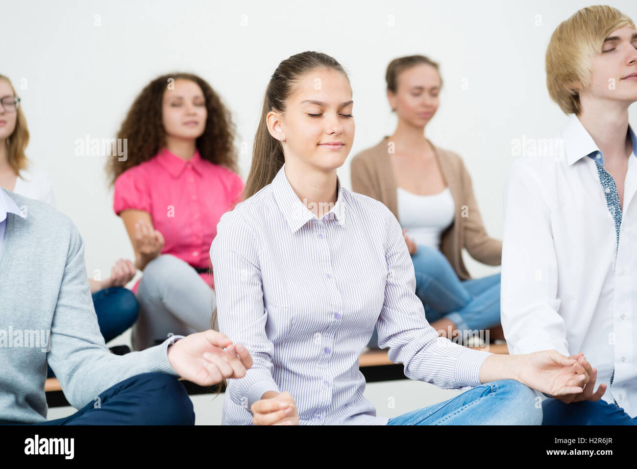 group of young people meditating Stock Photo - Alamy