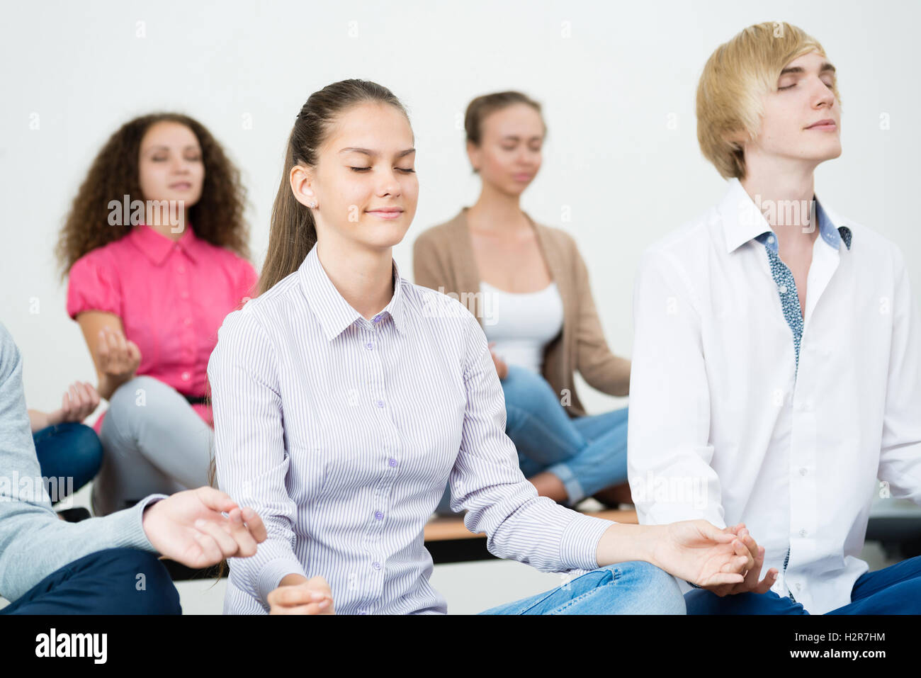 group of young people meditating Stock Photo - Alamy