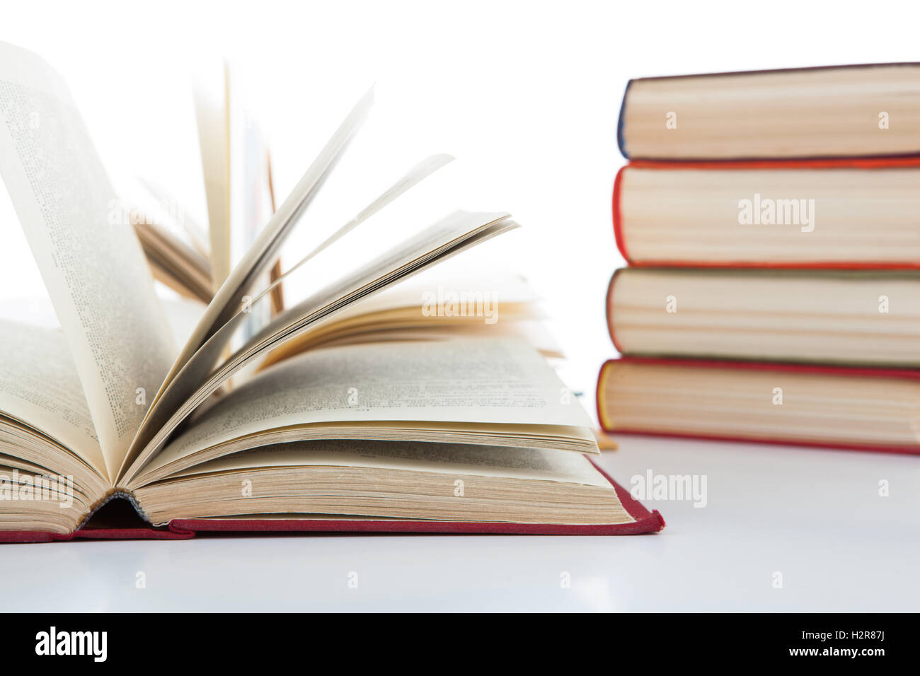 open books and stack of books on white Stock Photo - Alamy