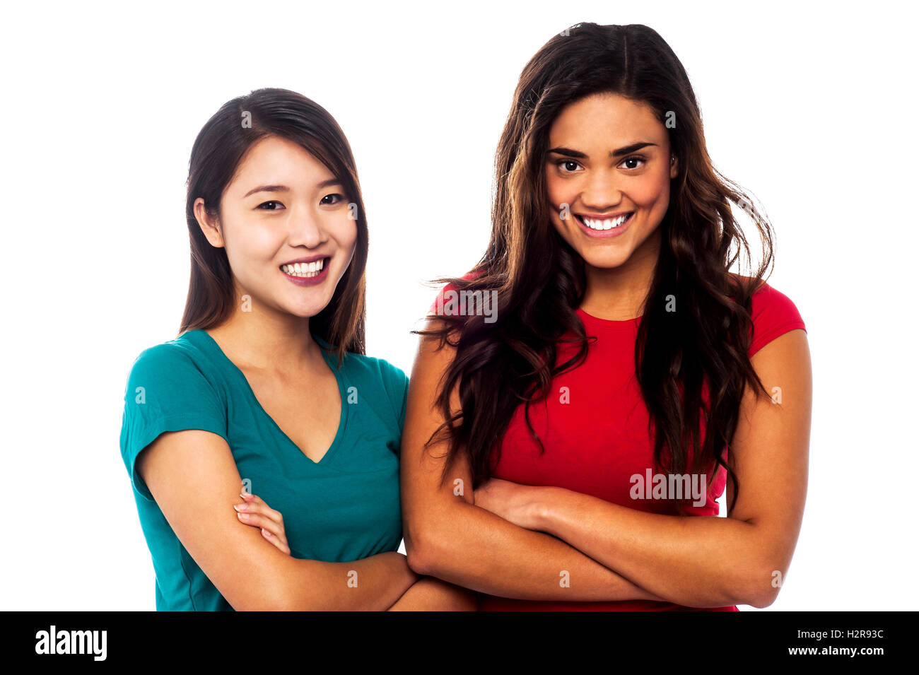 Pretty girls posing with arms crossed Stock Photo - Alamy