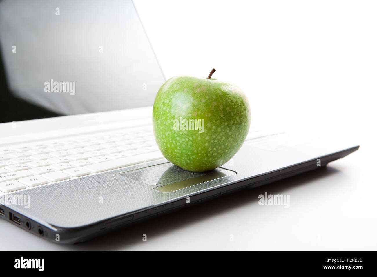 green apple on laptop keyboard Stock Photo - Alamy