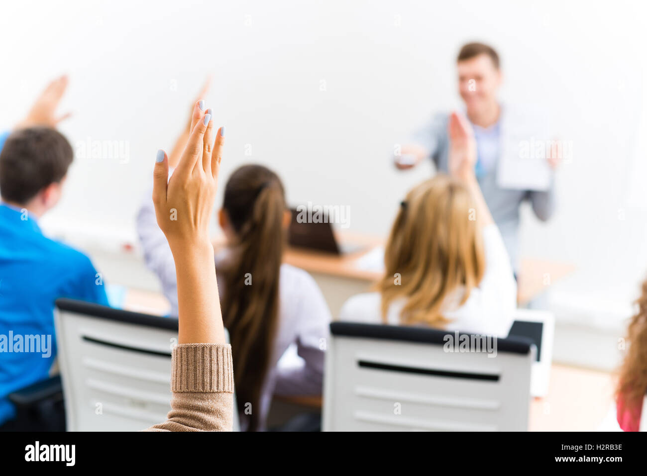 female hand raised in class Stock Photo - Alamy