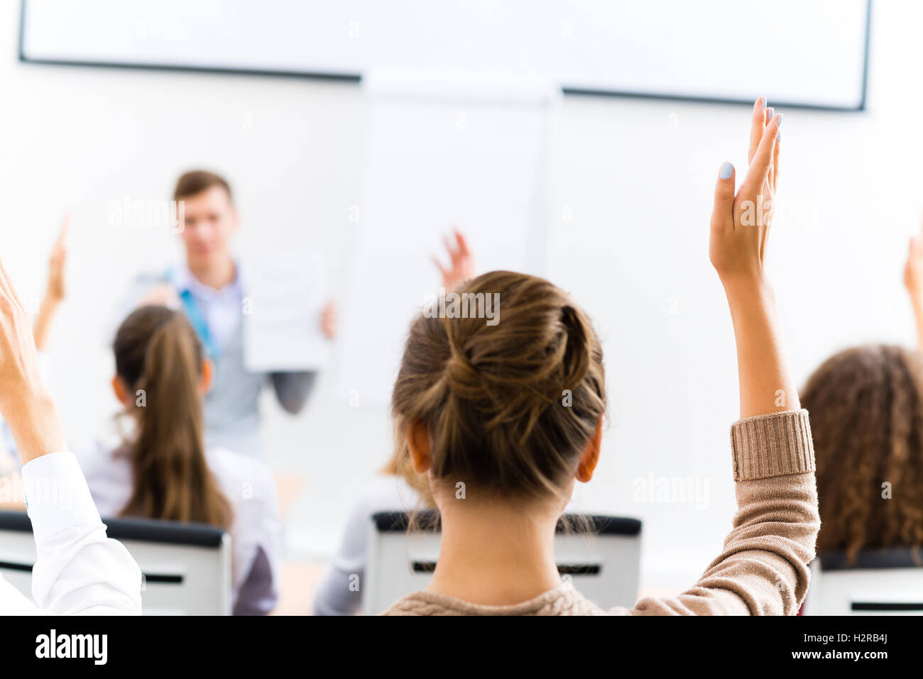 female hand raised in class Stock Photo - Alamy