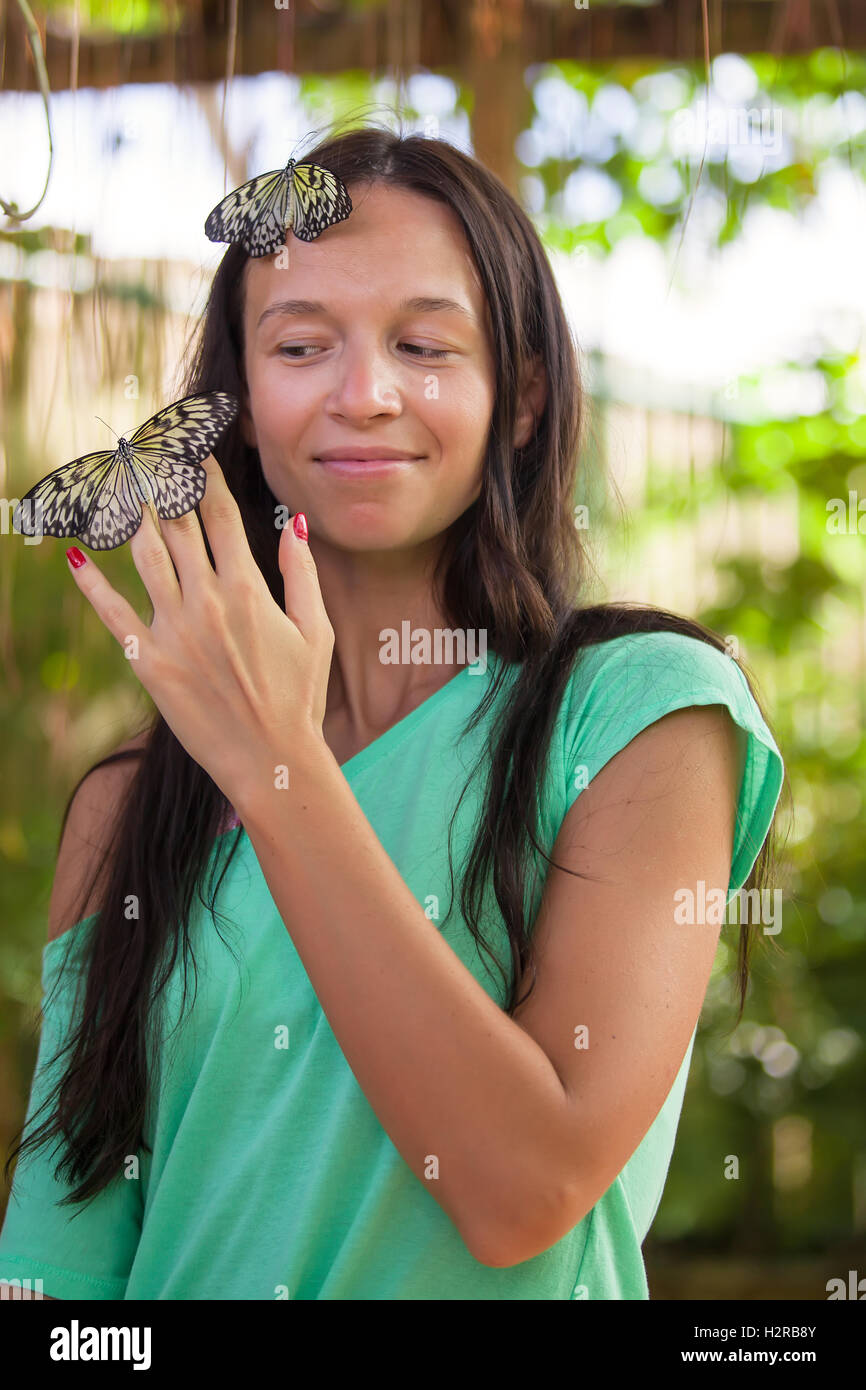 Young girl watching butterflies in a natural garden Stock Photo - Alamy