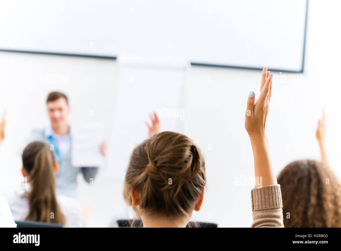 female hand raised in class Stock Photo - Alamy