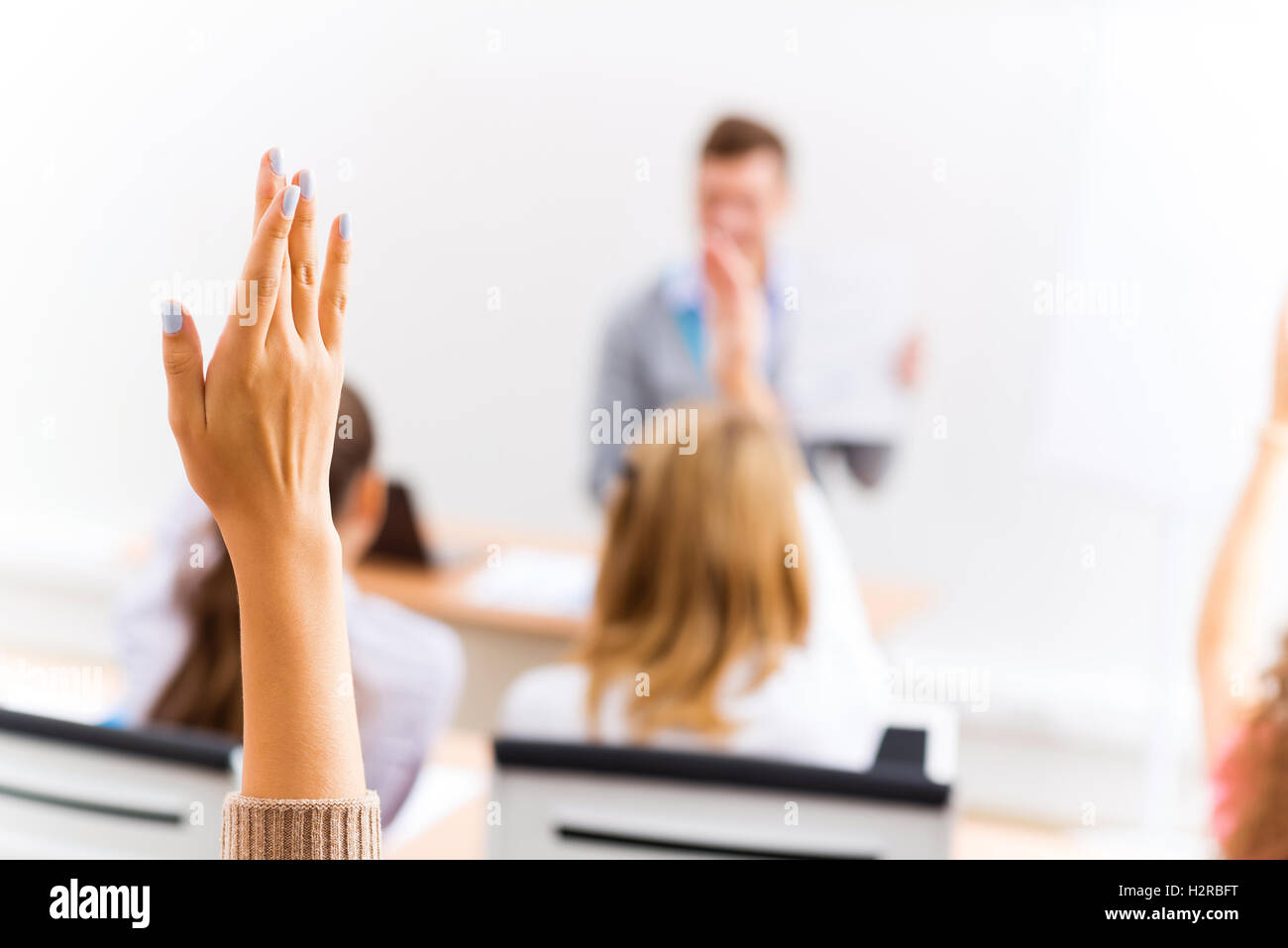 female hand raised in class Stock Photo - Alamy