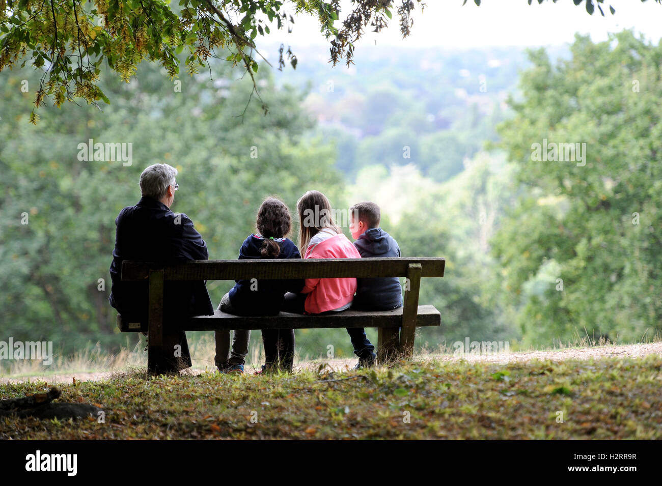 London, UK. 02nd Oct, 2016. Family sit on a bench in Richmond Park ...