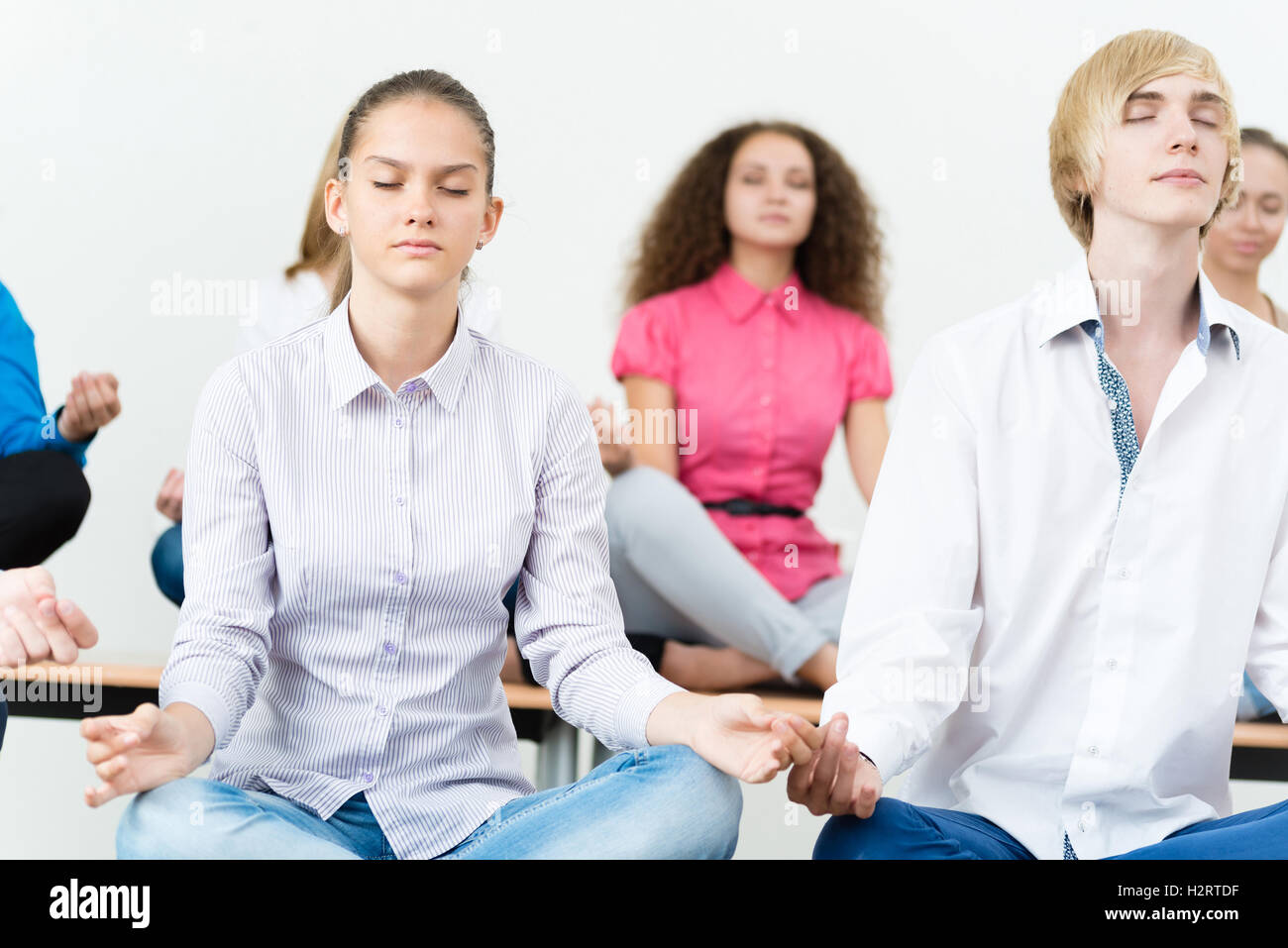 group of young people meditating Stock Photo - Alamy