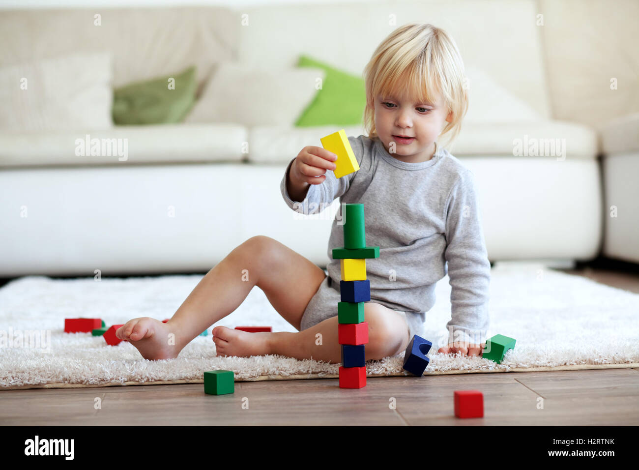 Toddler playing with wooden blocks Stock Photo - Alamy