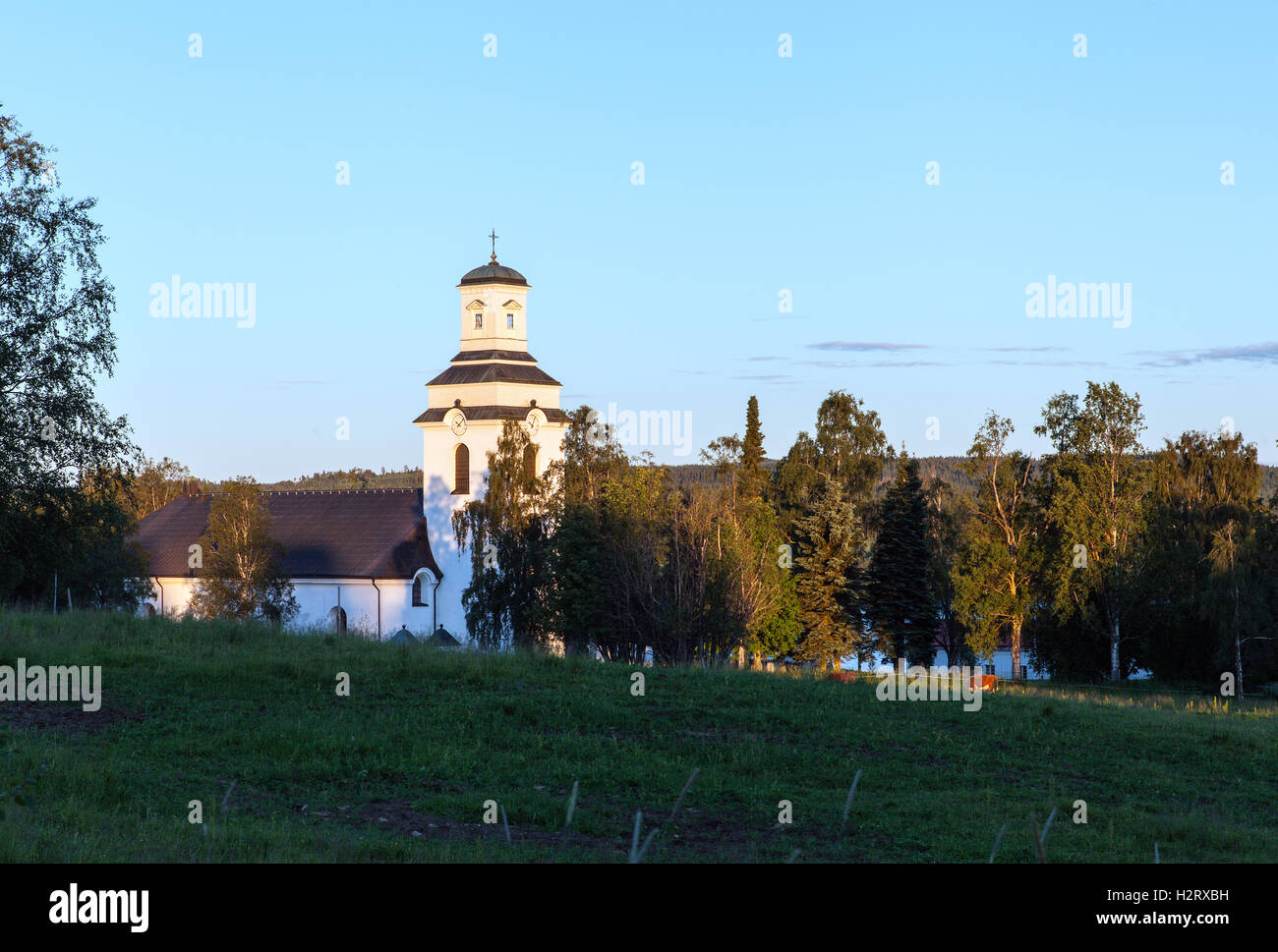 A church in a village, farmland this side. Summer and sunshine ...