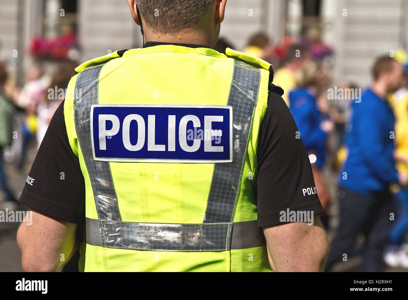 Police officer in hi-visibility jacket with text Police written. UK ...